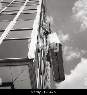 1960s, historical, two male window cleaners standing in a concrete pod ...