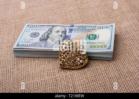 heart icon bundle of US dollar placed on a linen canvas Stock Photo - Alamy