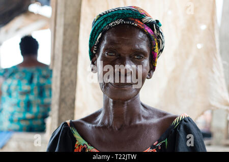 Adzopé, côte d'ivoire - June 10, 2017: old woman seated with legs bent ...