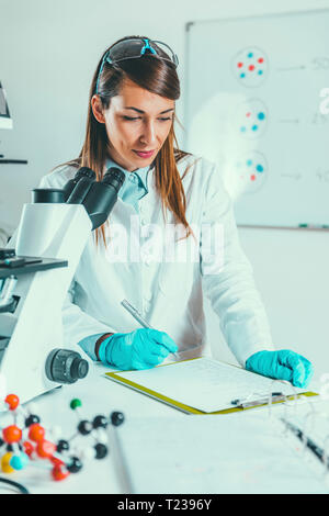 Life sciences, researcher taking observation notes Stock Photo - Alamy