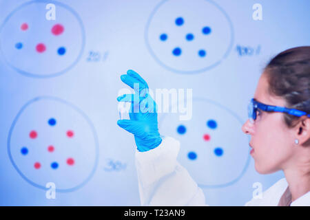 Young make scientist wearing goggles gloves and lab coat pouring bright ...