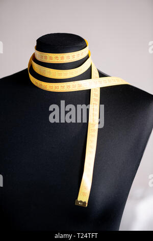 A mannequin with a tape measure around its neck, advertising made to ...