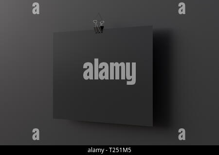 Blank horizontal black paper poster hanging on binder clip on black ...