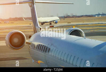Jet engine against a middle size plane at the airport on loading ...