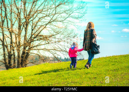 mom and daughter walk together outside Stock Photo - Alamy