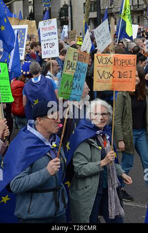A protester holds placard in support of minority rights alongside ...