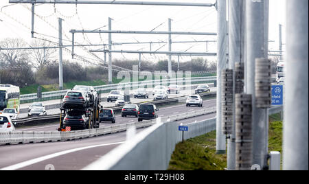 Reinfeld, Germany. 30th Mar, 2019. Cars and trucks drive past newly ...