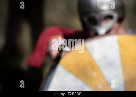 Viking behind round shield wearing spectacled Gjermundbu helm pointing ...