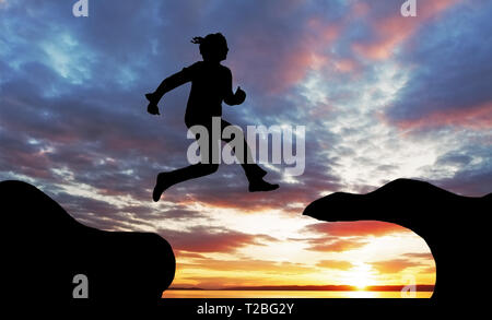 Woman jump over canyon at a sunset Stock Photo - Alamy