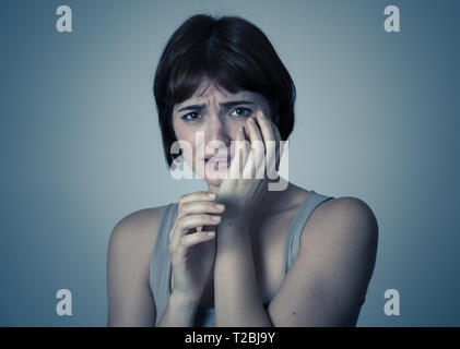Young woman feeling scared and shocked making fear, anxiety gestures ...