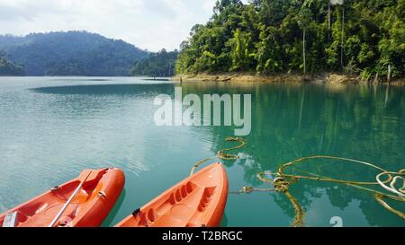 orange paddle boats in khao sok for kayaking Stock Photo - Alamy