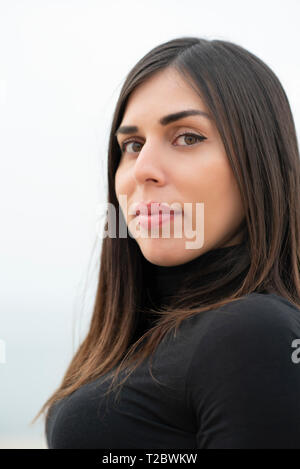 Beautiful arab woman looking at camera through fingers Stock Photo - Alamy