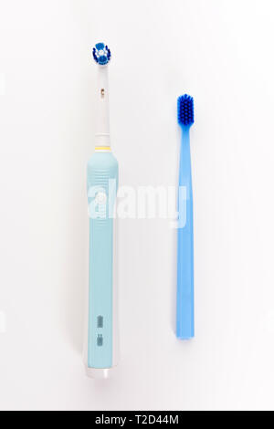 Manual regular Toothbrush Against Modern Electric Toothbrush. Isolated ...