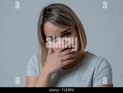 Depressed young woman covering her sad face with smiling mask. Mental ...