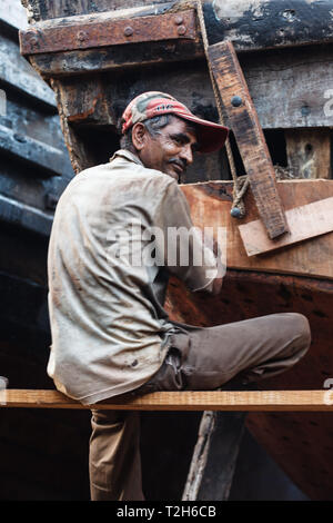 Portrait of male worker repairing boat engine in docks, copy space ...