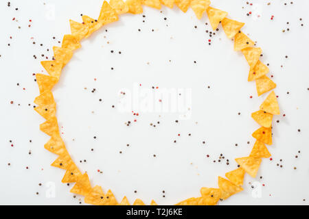 top view of tasty nachos and spices on white background with copy space ...