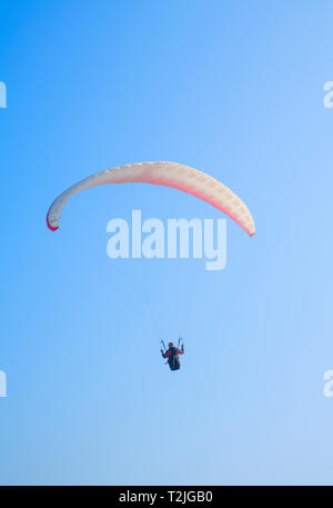 High flyer paraglider against blue sky Stock Photo - Alamy