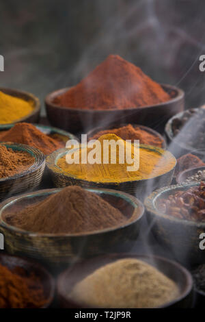 Smoke, Aromatic spices on wooden background Stock Photo - Alamy