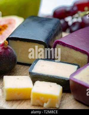 Mini black and dark red waxed cheddar cheeses made from West Country ...