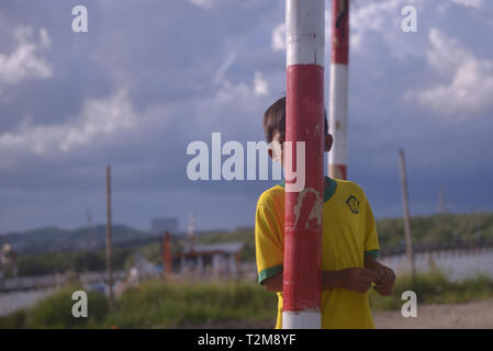 Local child seen hiding behind a pole at the island. Pasaran is a ...