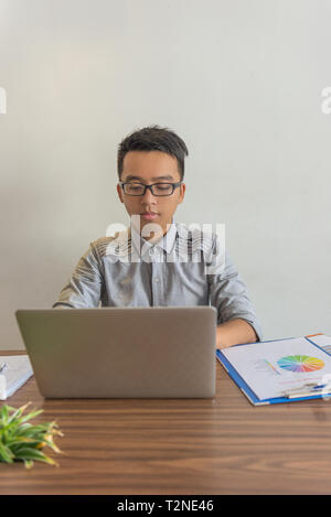 Vertical photo of young office man using tablet Stock Photo - Alamy