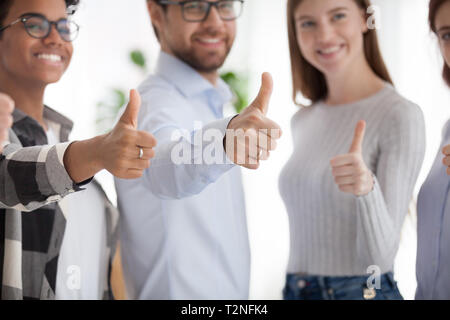 Happy multiracial millennial people showing mobile phones, mockup ...