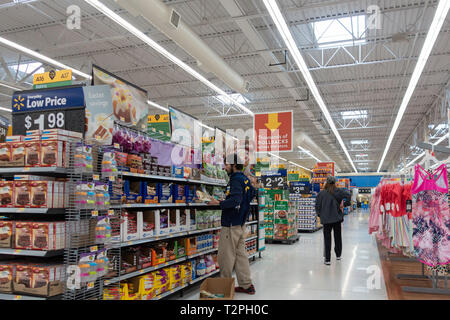 Walmart store interior with male employee stocking a shelf. USA Stock ...