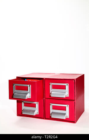 Red filing cabinet isolated on white background Stock Photo - Alamy