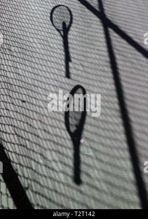 Shadows of tennis rackets on the ground Stock Photo - Alamy