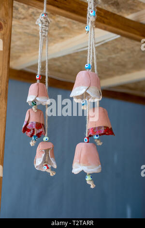A bunch of colorful miniature bells hanging on display Stock Photo - Alamy