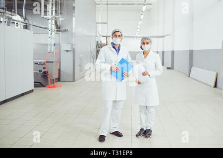 People technologists in masks at food factory Stock Photo - Alamy