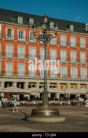 People on the Plaza Mayor encircled by old large building with ...