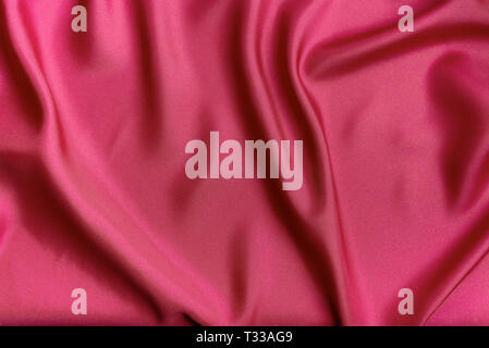 Smooth elegant shiny red silk or satin luxury cloth texture can use as ...