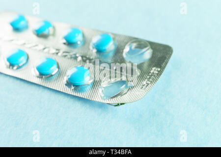 Close up of pink and blue Amoxicillin antibiotics capsule pills ...