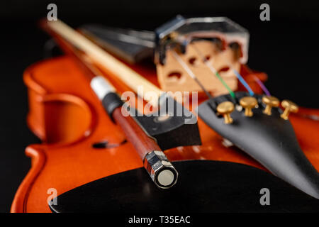 Beautiful new shiny violin on a dark table. Musical string instrument ...