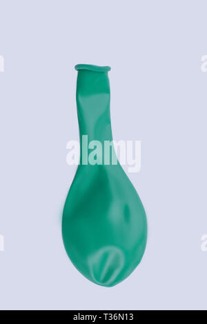 Deflated green balloon isolated on white background Stock Photo - Alamy