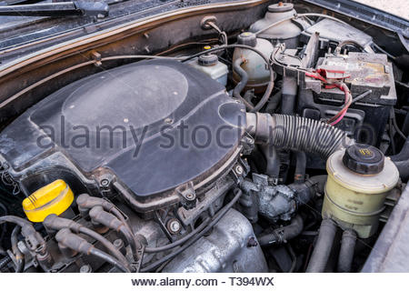 Old broken and dirty car engine close up, view under the hood in sepia ...