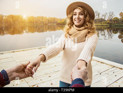 Follow me, Happy young blonde woman in white flowers dress Stock Photo ...