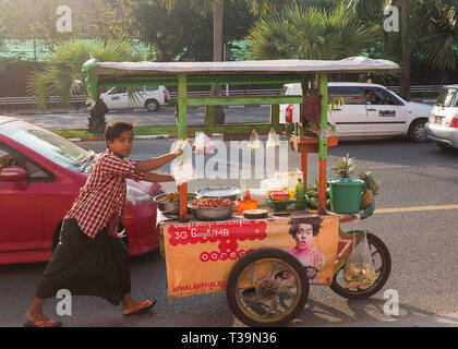 A man / food vendor pushing a push style food cart in Little Italy, New ...