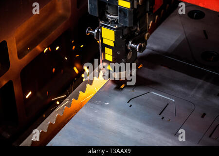 A technician is welding sheet metal with a welding machine in a factory ...