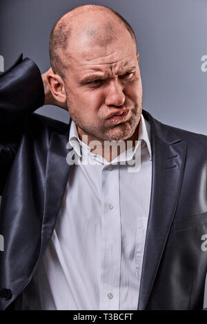 Unhappy stressed bald angry business man to scratching the head with ...