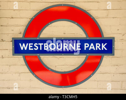 London Underground emblem bearing the name of the station on the wall ...