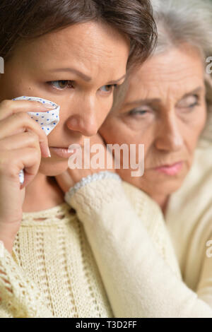 Sad senior and young women Stock Photo - Alamy