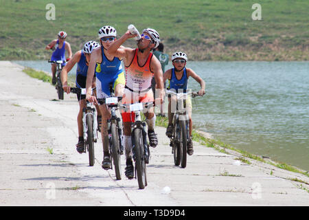 Mountai bike cyclists arriving at triathlon competition at Lake Bezid ...
