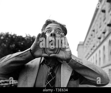 Close up of a man practing his hog calling ca. 1937 Stock Photo - Alamy