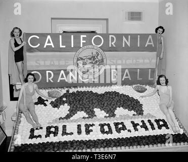 Women posing with California orange week festival ball display ca. 1938 ...