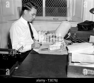 An agent cecking over confiscated counterfeit currency at the Secret ...