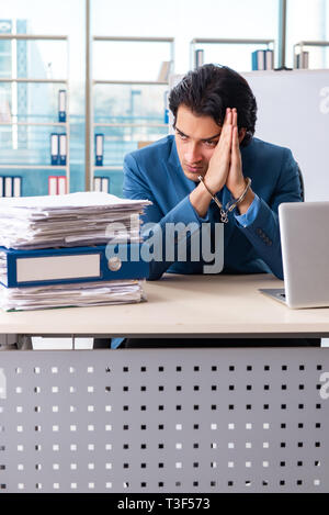 Chained employee unhappy with excessive work in the ofiice Stock Photo ...