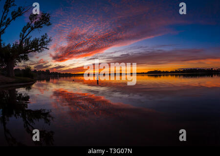 Cottage lake sunset with gorgeous pink,blue,magenta and orange sky on a ...