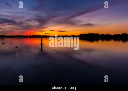 Cottage lake sunset with gorgeous pink,blue,magenta and orange sky on a ...